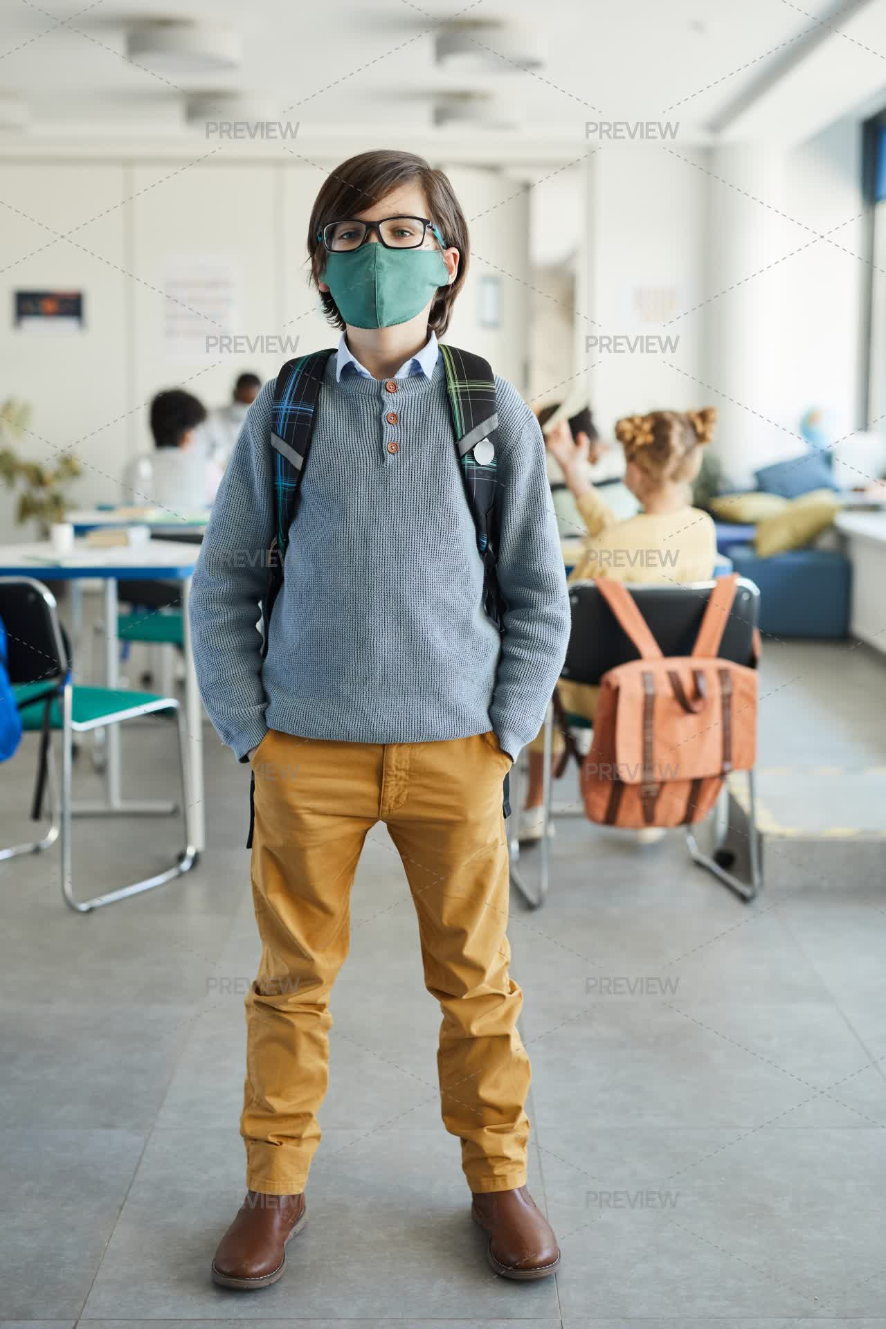 Schoolboy Wearing Mask In Classroom - Stock Photos | Motion Array Schoolboy Wearing Mask In Classroom - Stock Photos | Motion Array